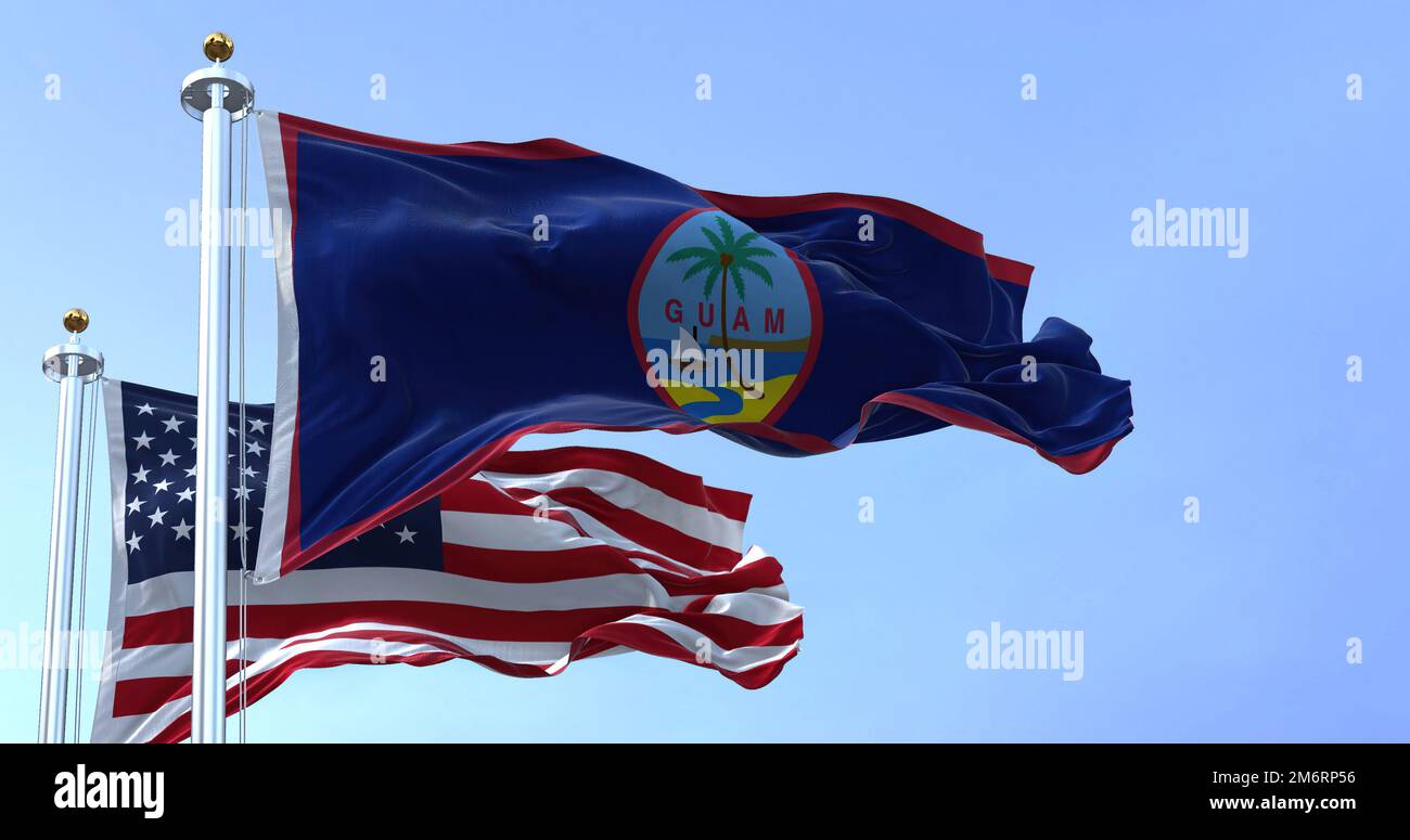 Flag of Guam waving in the wind with the US flag on a clear day Stock ...