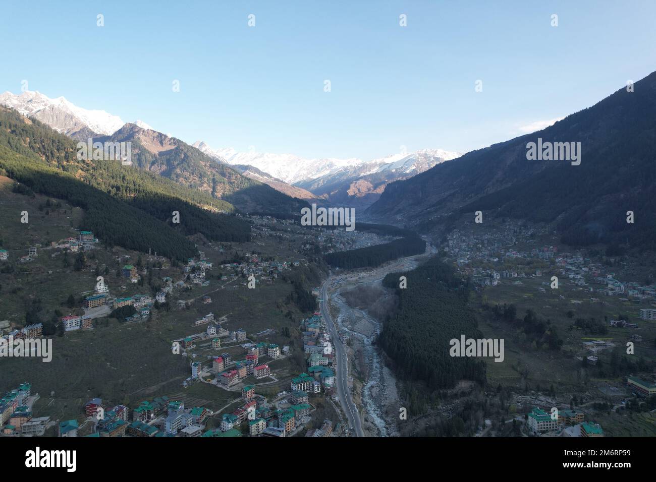 An aerial view of rural fields, houses, and mountains in the ...