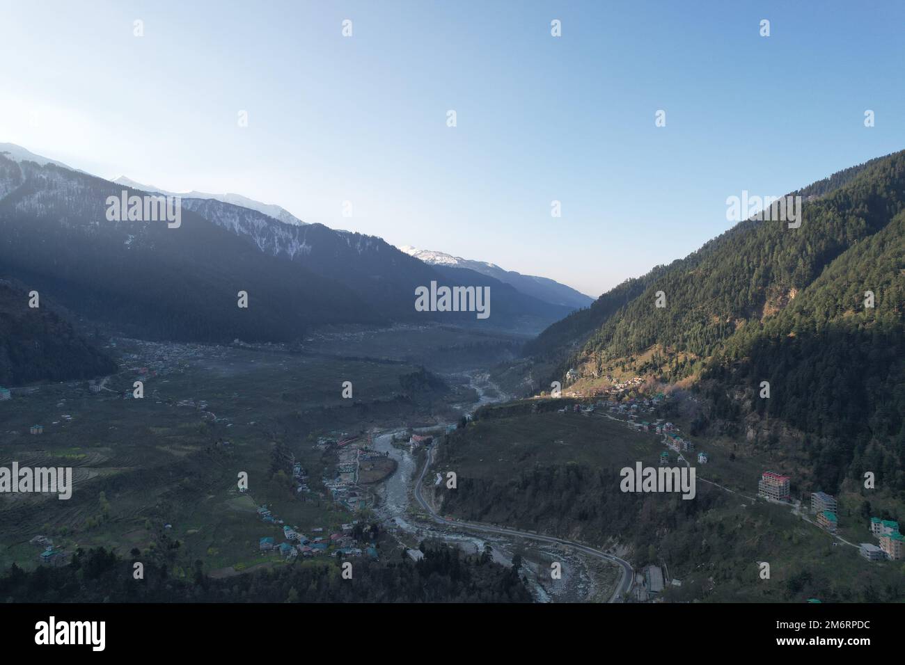 An aerial view of rural fields, houses, and mountains in the ...