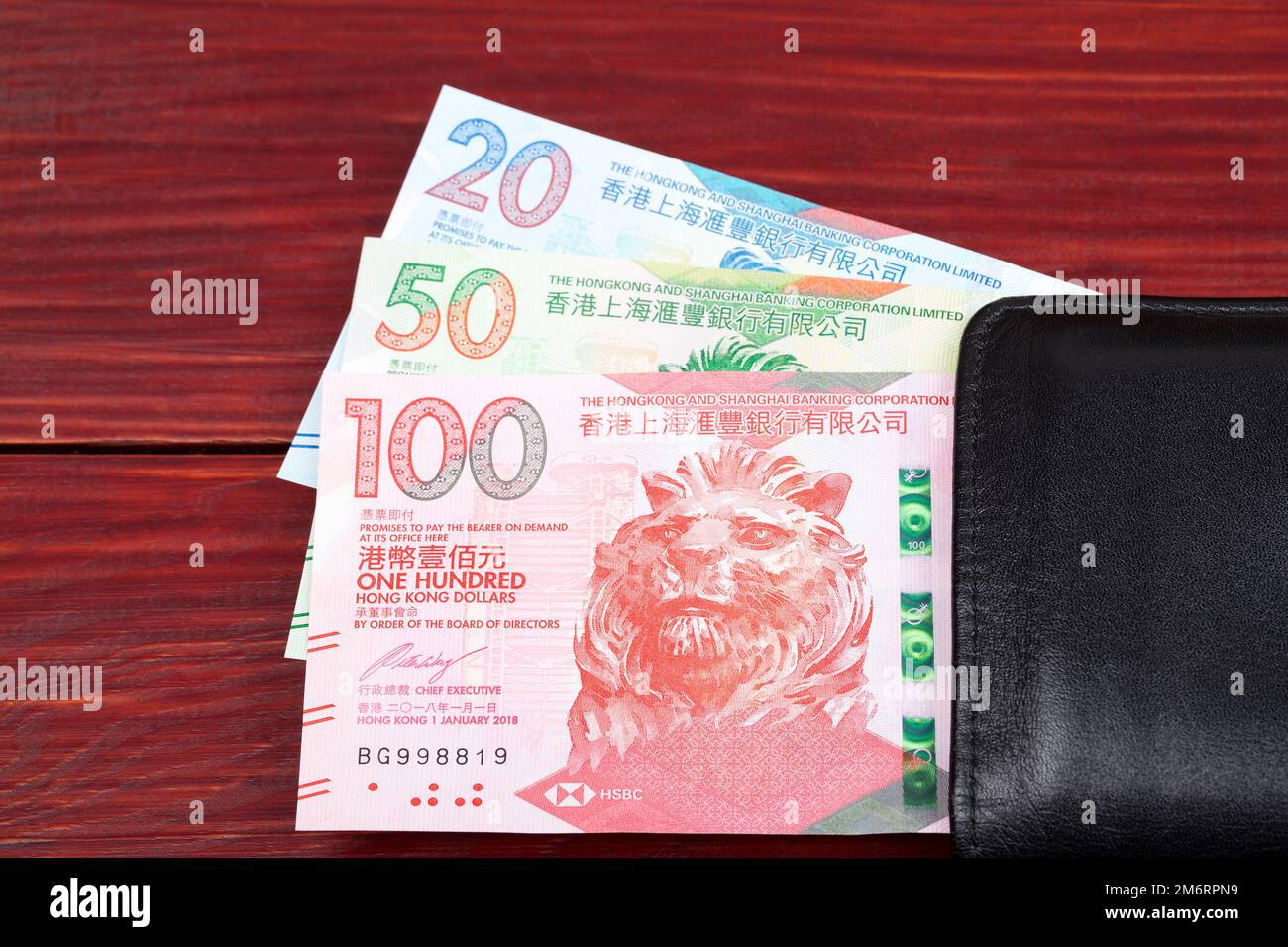 Hong Kong dollar a new series of banknotes in the black wallet Stock ...