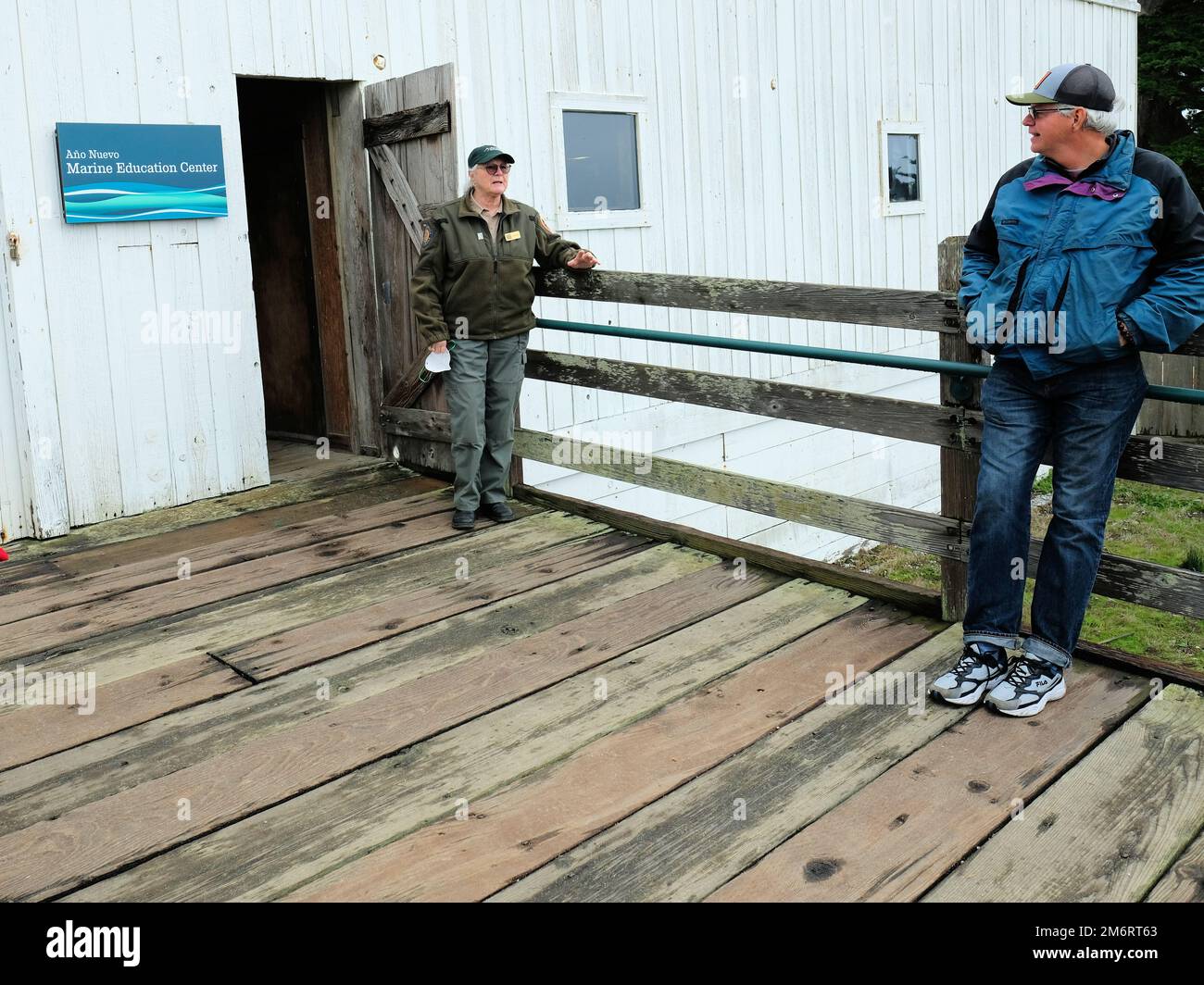 Park employee and guest outside the Marine Education Center at the Año ...