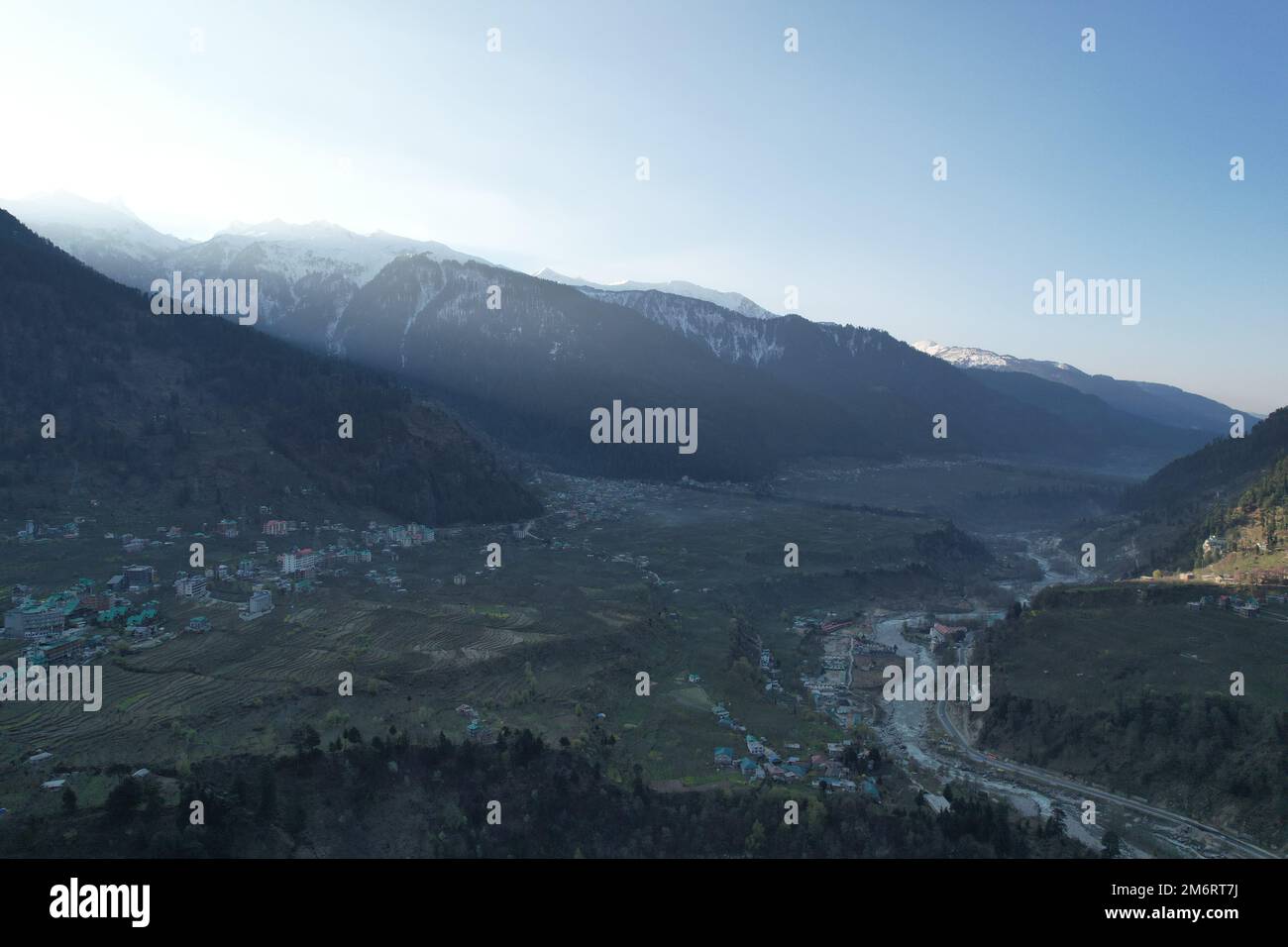 An aerial view of rural fields, houses, and mountains in the ...