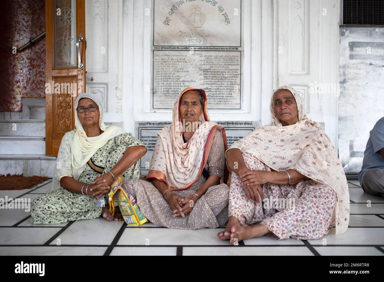 Indian woman in Indian robes and barefoot at the Hari Mandir or Golden ...