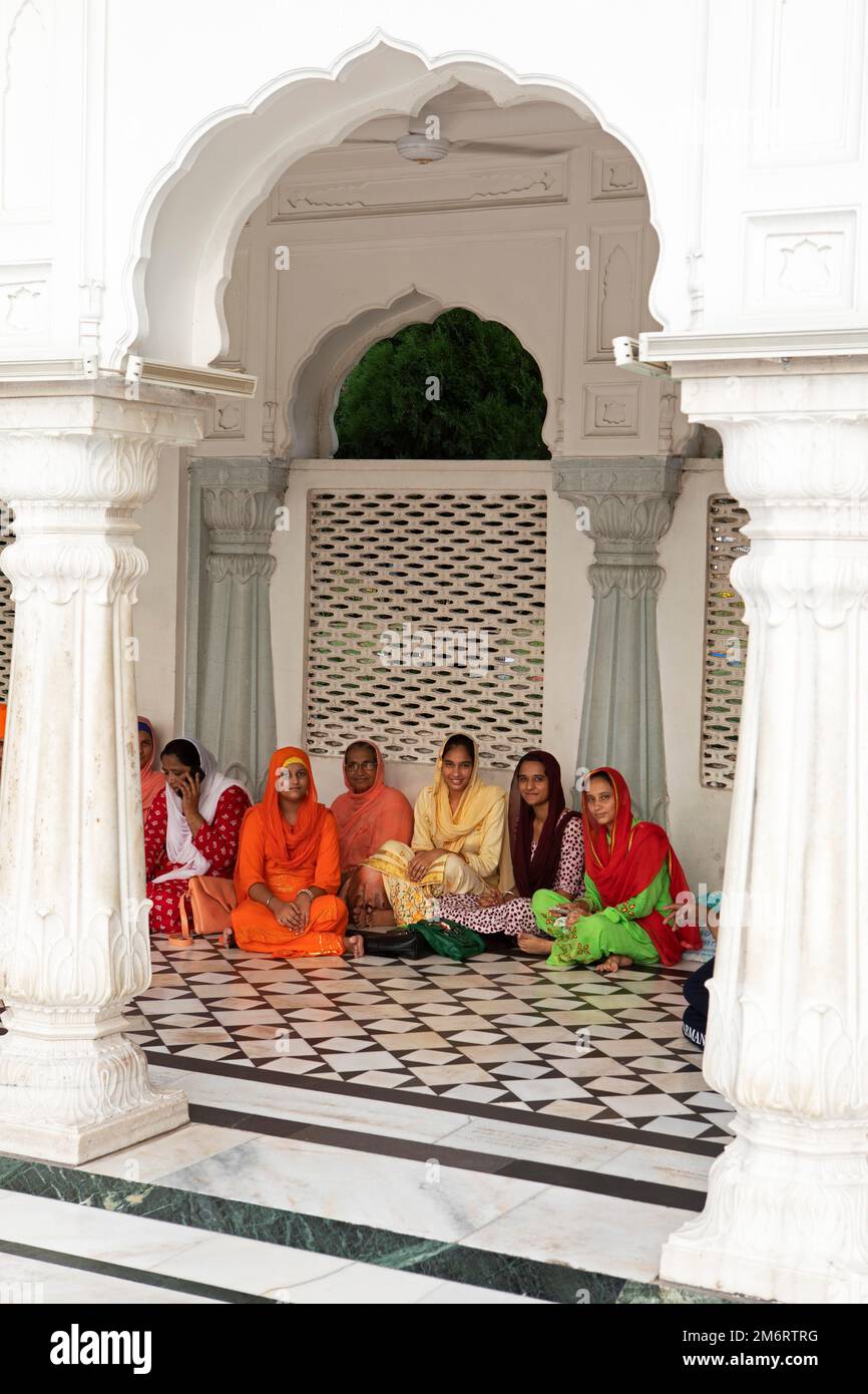 Indian woman in Indian robes and barefoot at the Hari Mandir or Golden ...