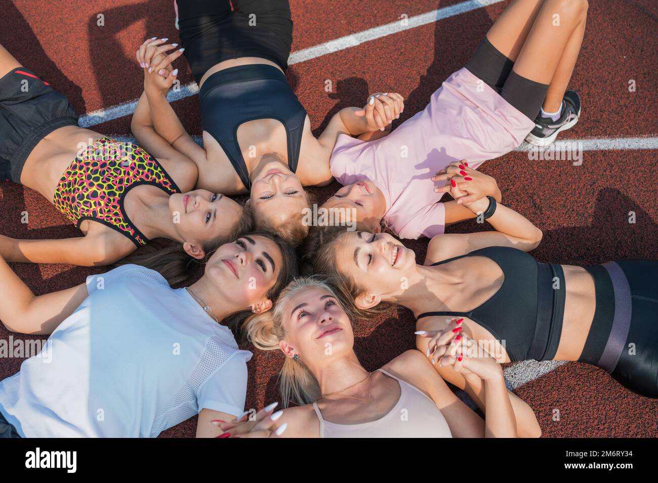 Group of children and young girls with female coach Stock Photo - Alamy