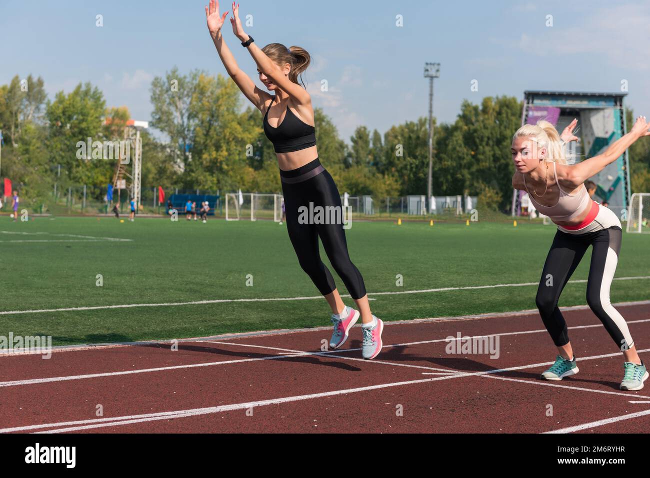 Two athlete woman runnner are training Stock Photo - Alamy