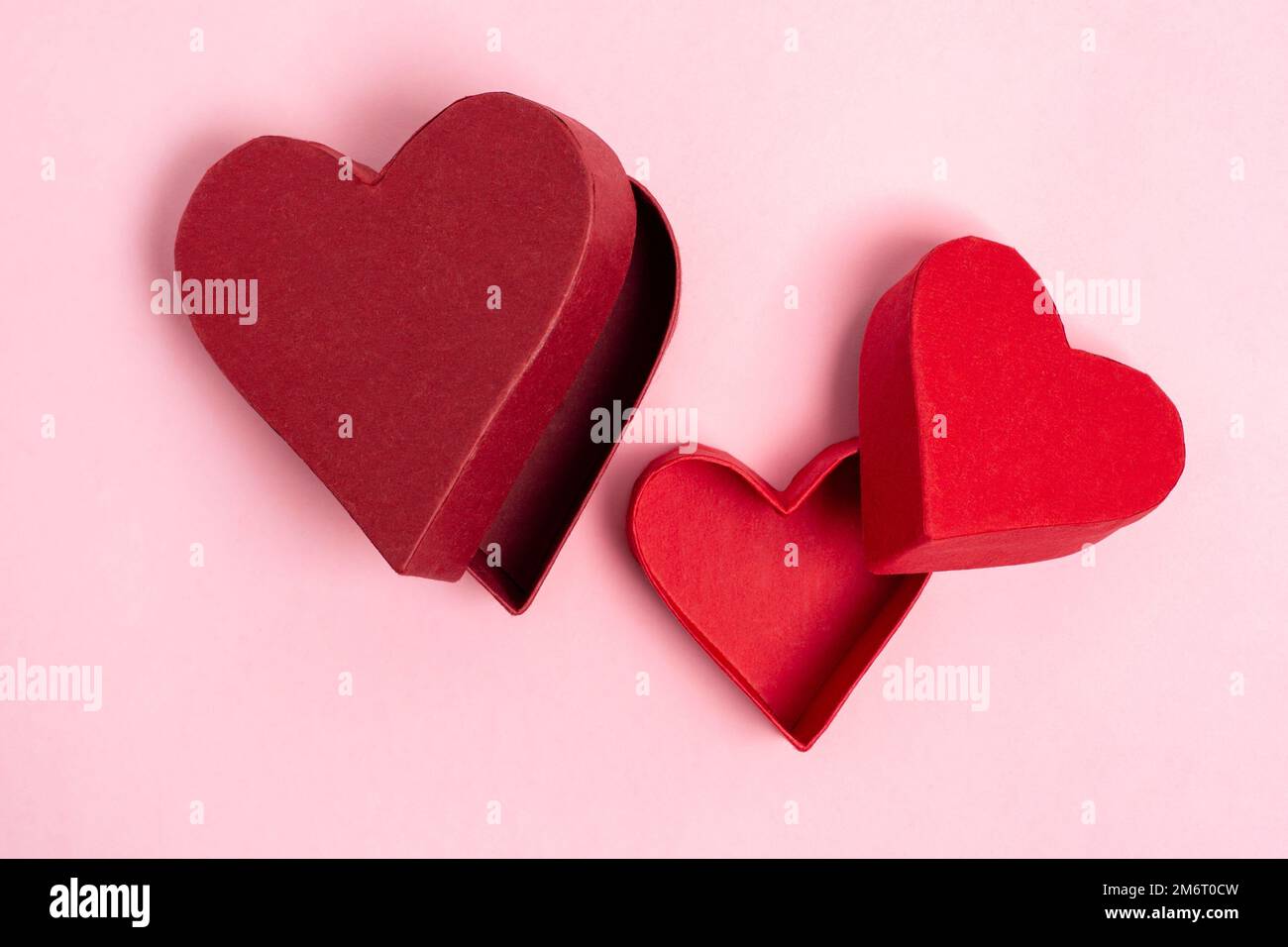 Beautiful closeup of red heart boxes on pink background. Shape ...