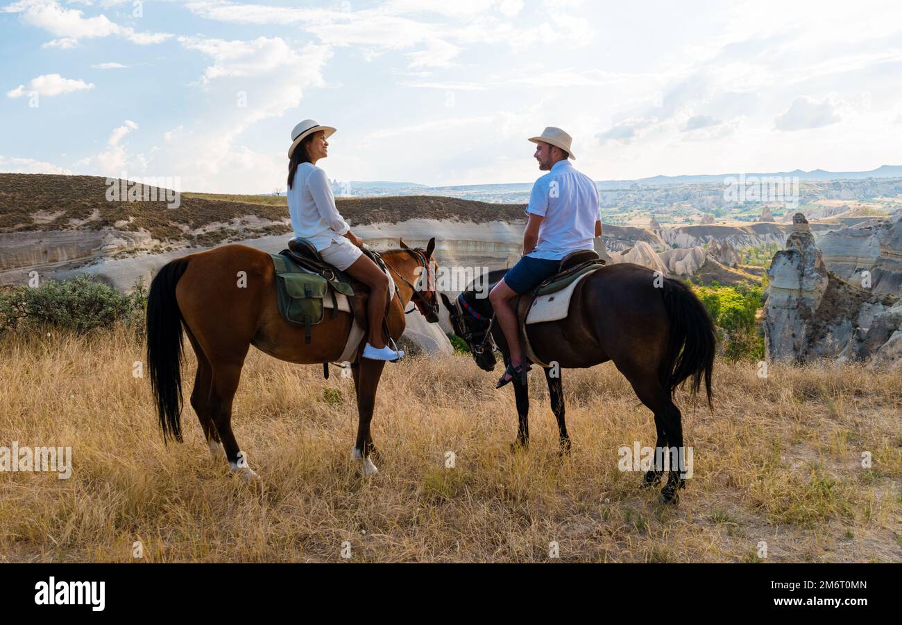 Happy young couple on vacation Turkey Kapadokya horse riding in the ...
