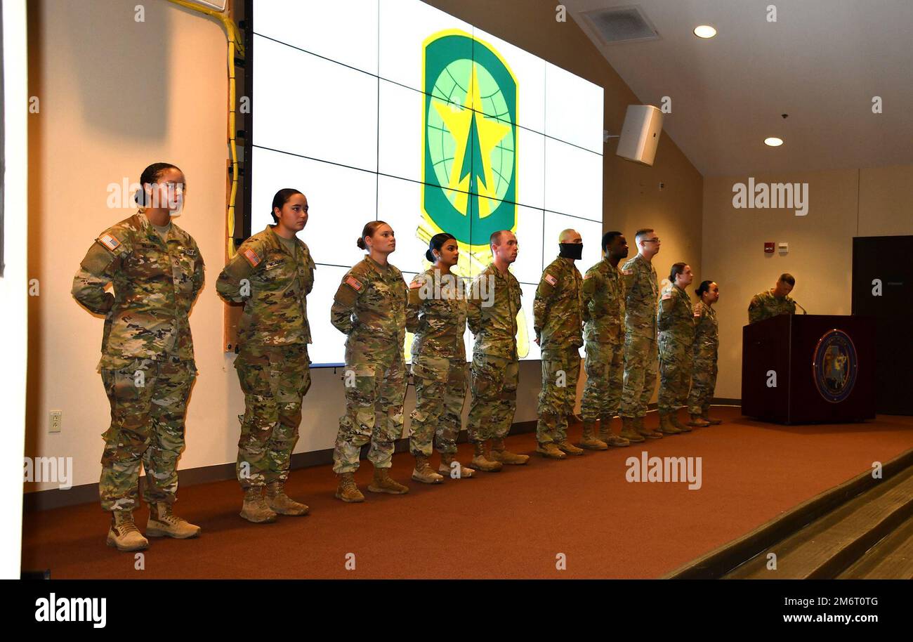 The first graduating class of the Protect Program stands at parade rest ...