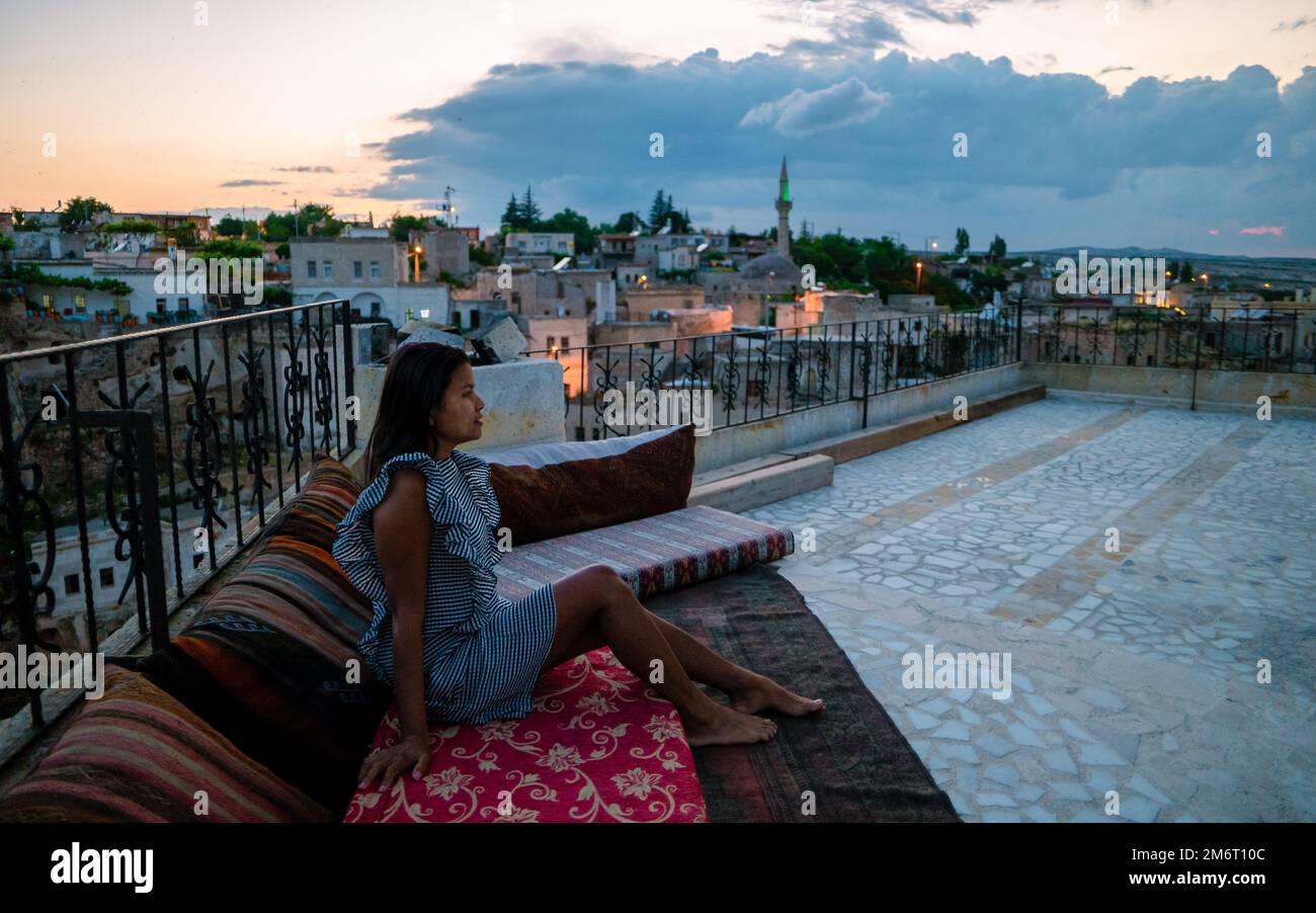 Couple with drink on rooftop of an cave house historical village of ...