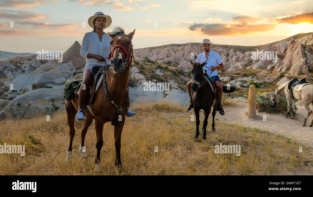 Happy young couple on vacation Turkey Kapadokya horse riding in the ...