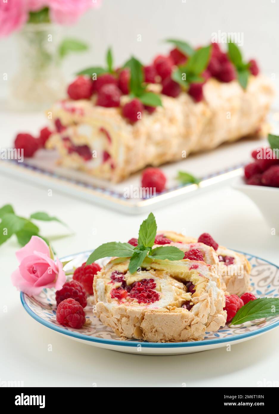 Baked meringue roll with cream and fresh red raspberry, white ...