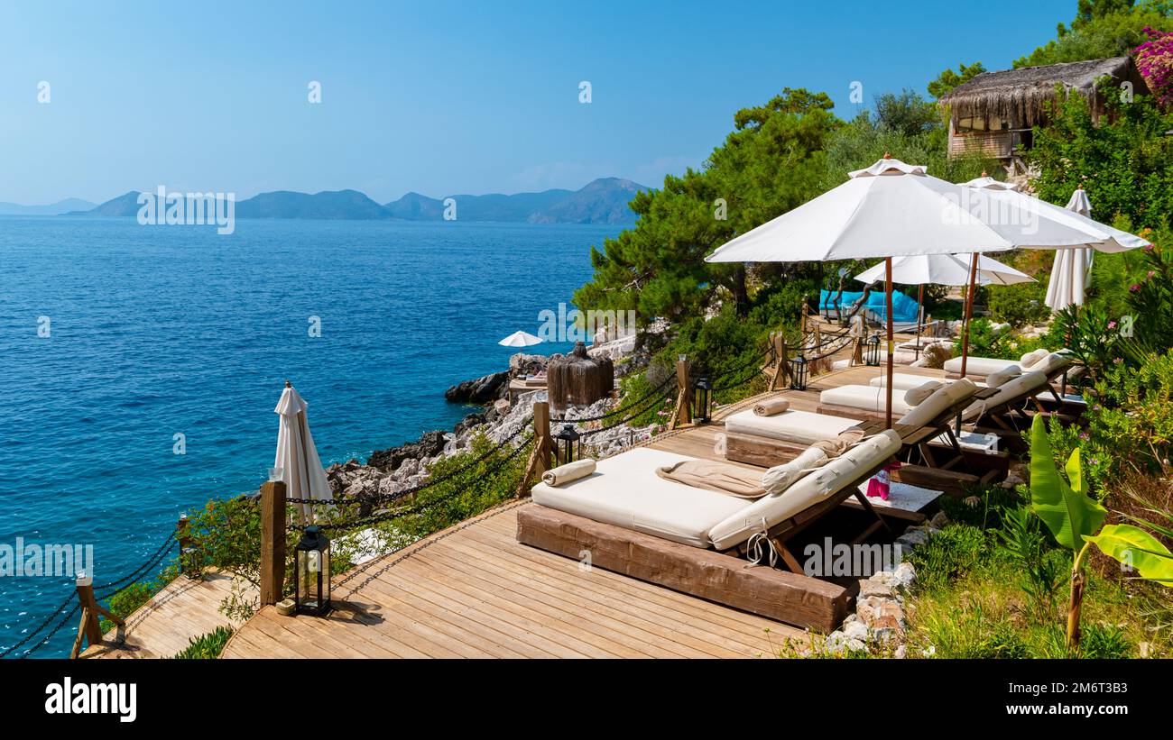 Beach beds with white umbrellas looking out over the ocean in Turkey ...