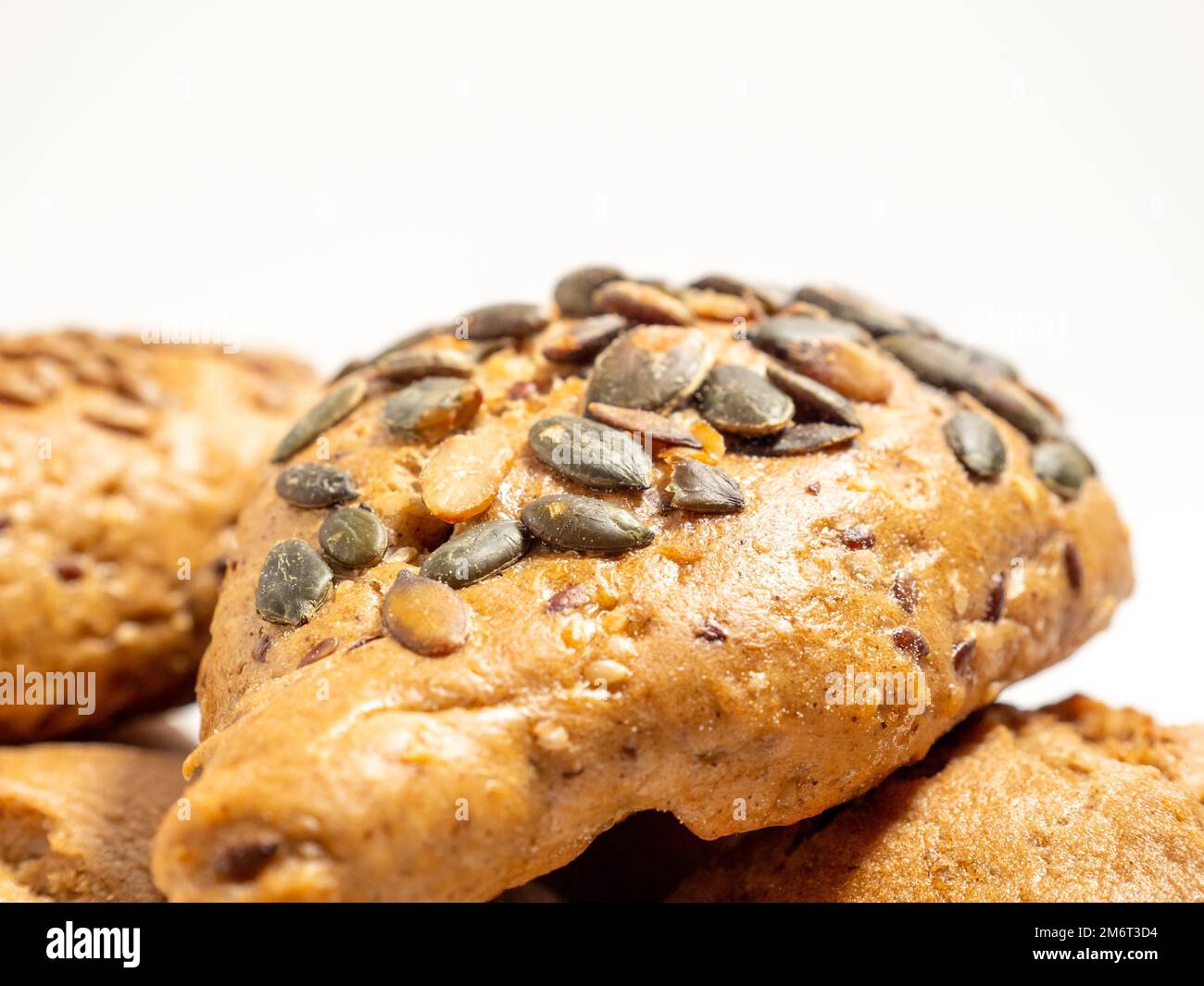 Dark buns on a white background. Bakery products with grains. Close-up ...