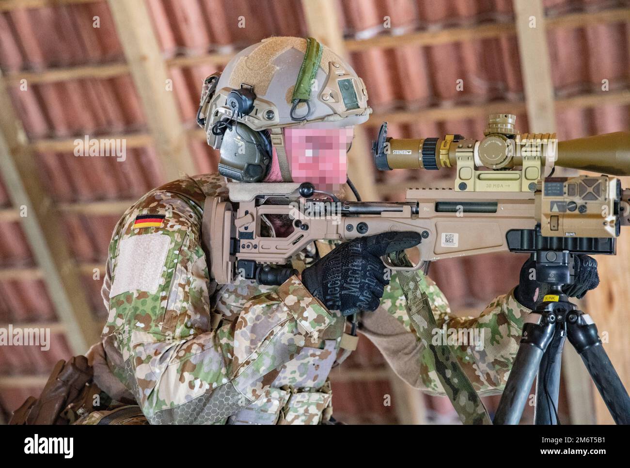 A German Special Forces sniper engages a target during the ...
