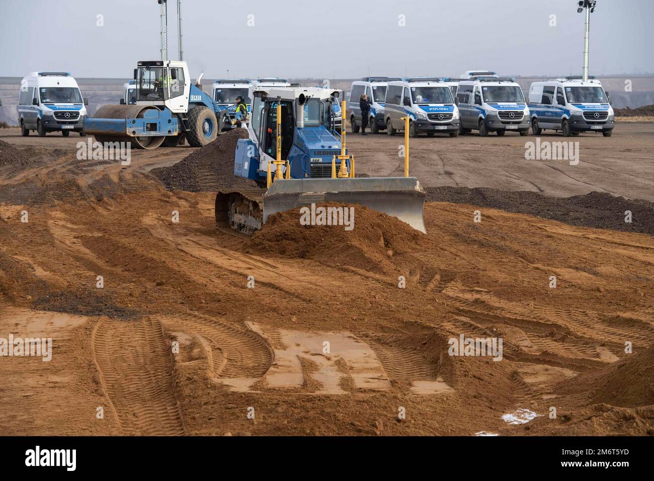 Bulldozer at work, in the background police vehicles, construction ...