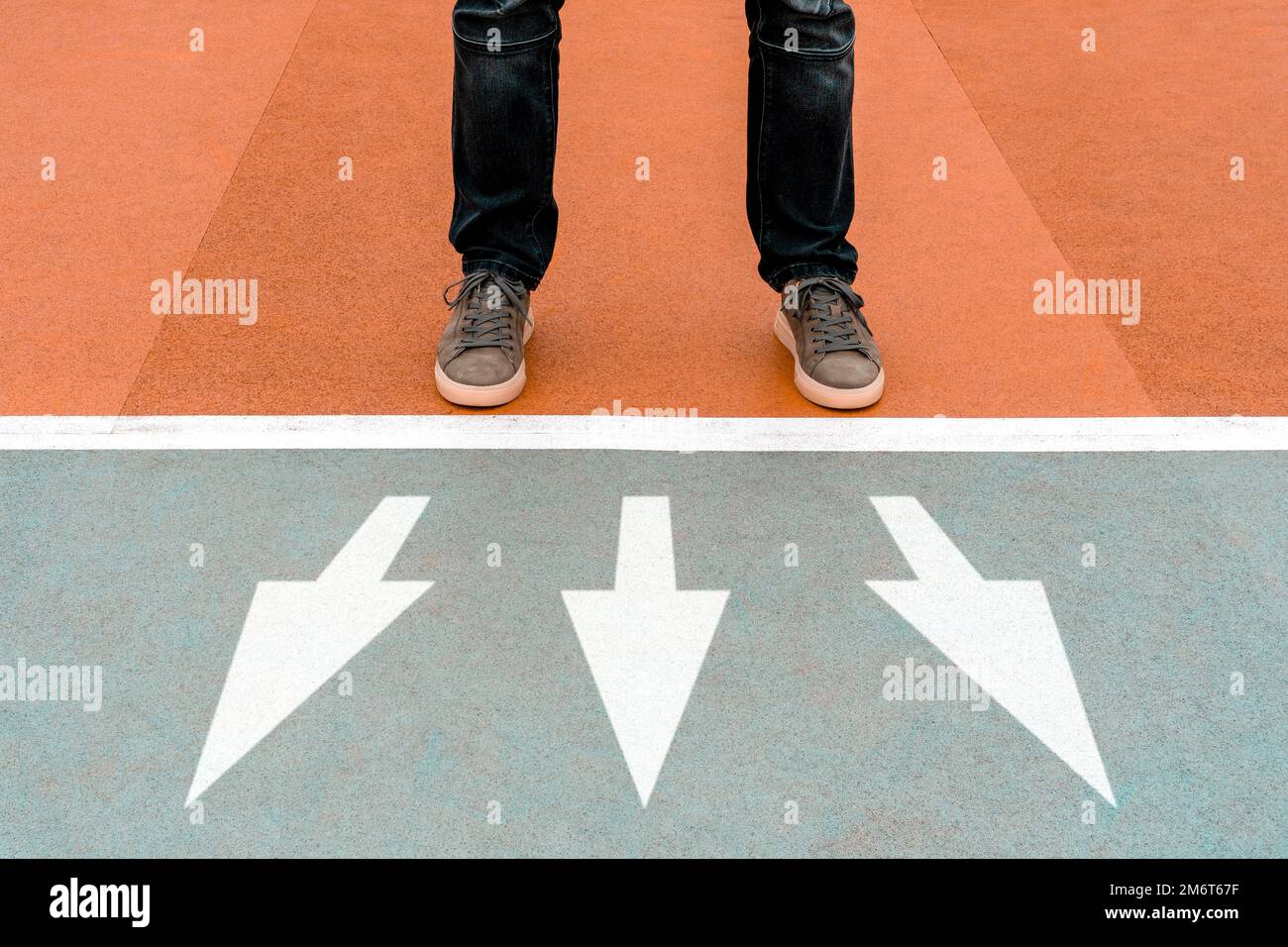 Feet and three arrows painted on rubberized surface Stock Photo - Alamy
