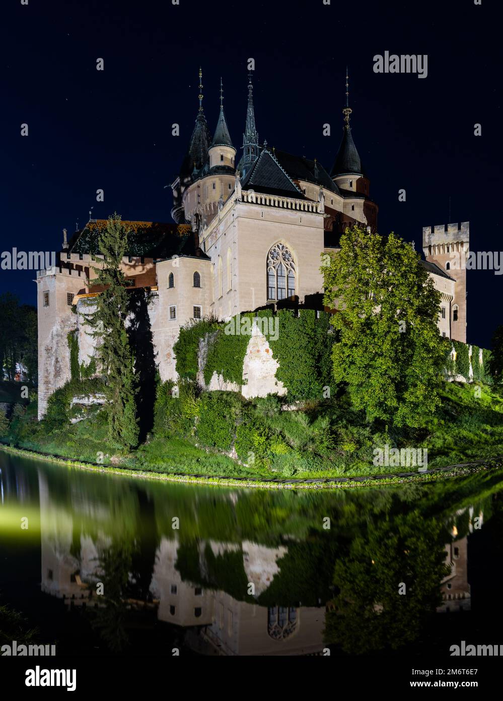 View of the Bojnice Castle with reflections in the water at night Stock ...