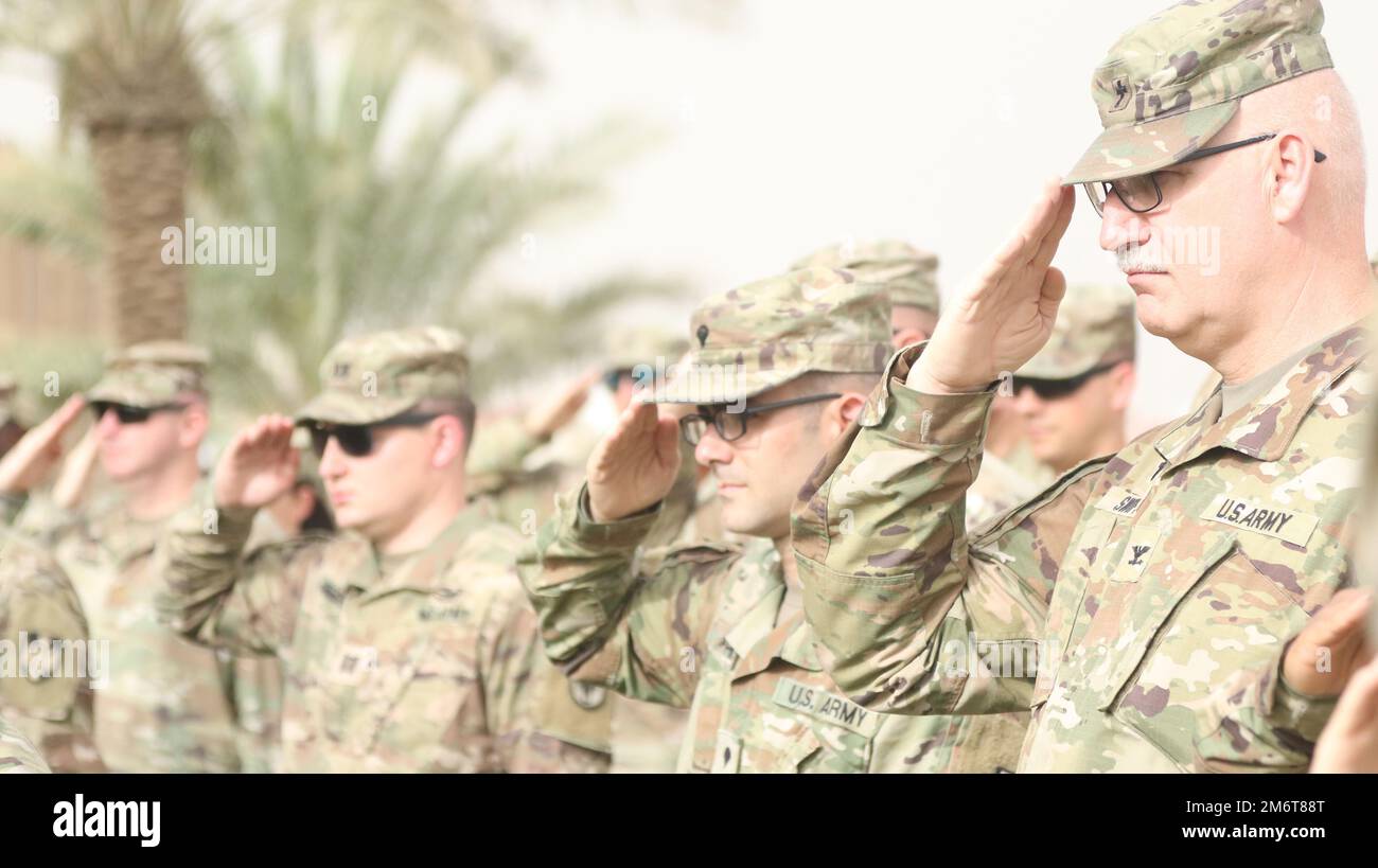 Soldiers from across Arifjan salute the flag during the singing of the ...