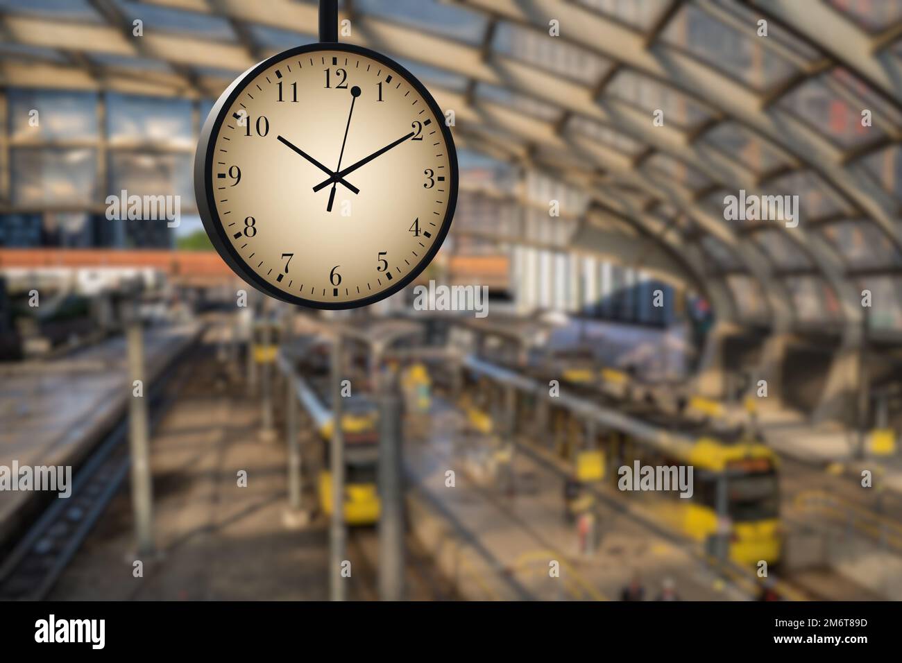 Old fashioned station clock on blurry train station background ...