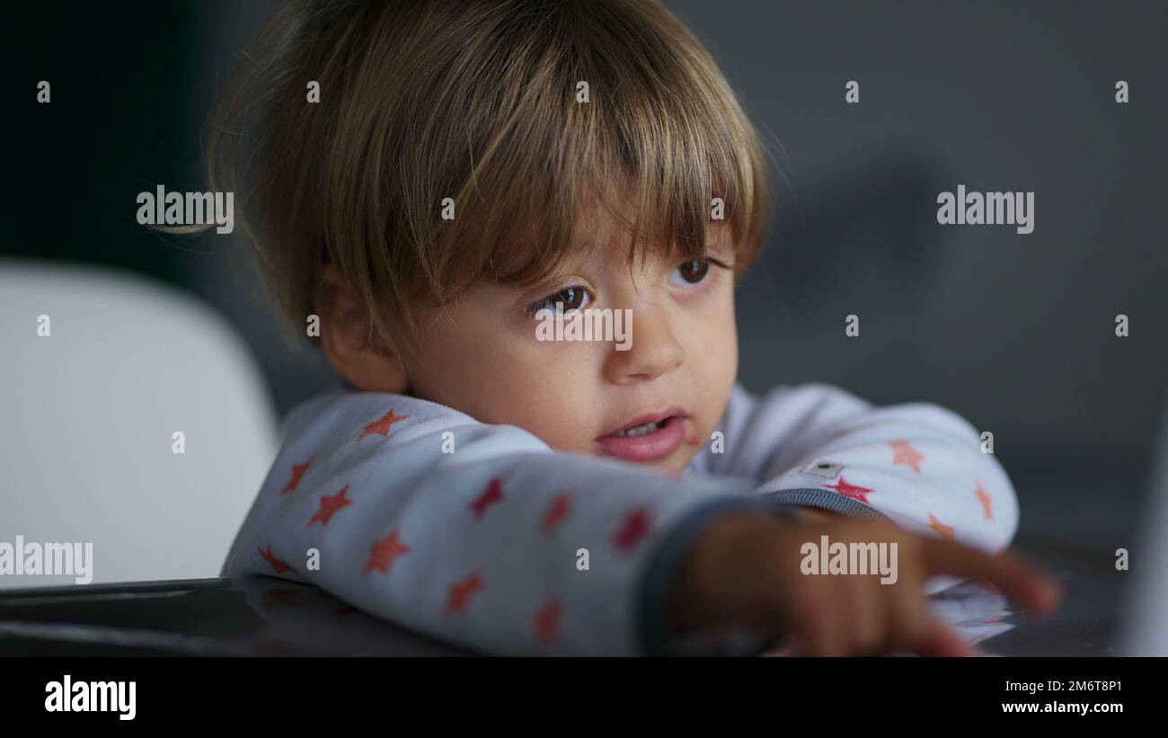 Little baby toddler pointing finger at screen watching content Stock ...
