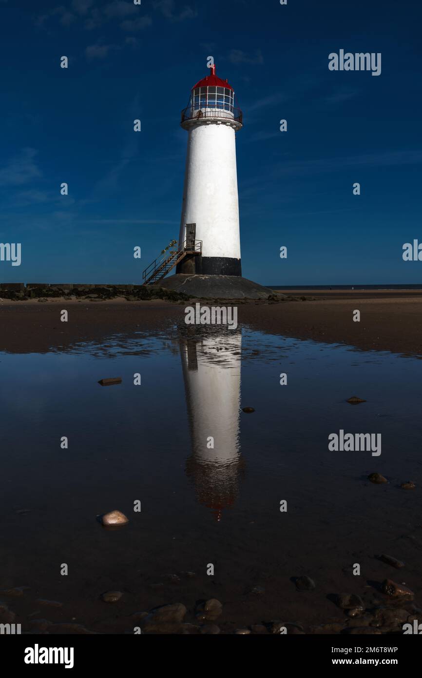 Low-key vertical view of the Point of Ayr Lighthouse in North Wales ...