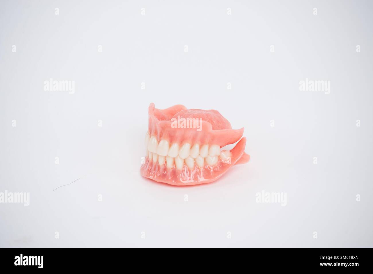 Dental prostheses on a white background. Beautiful teeth ceramic press ...