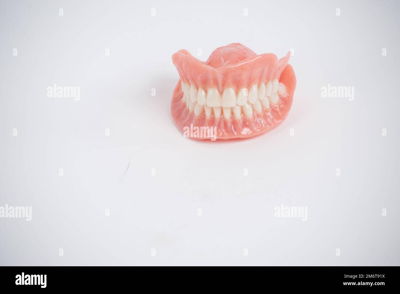 Dental prostheses on a white background. Beautiful teeth ceramic press ...