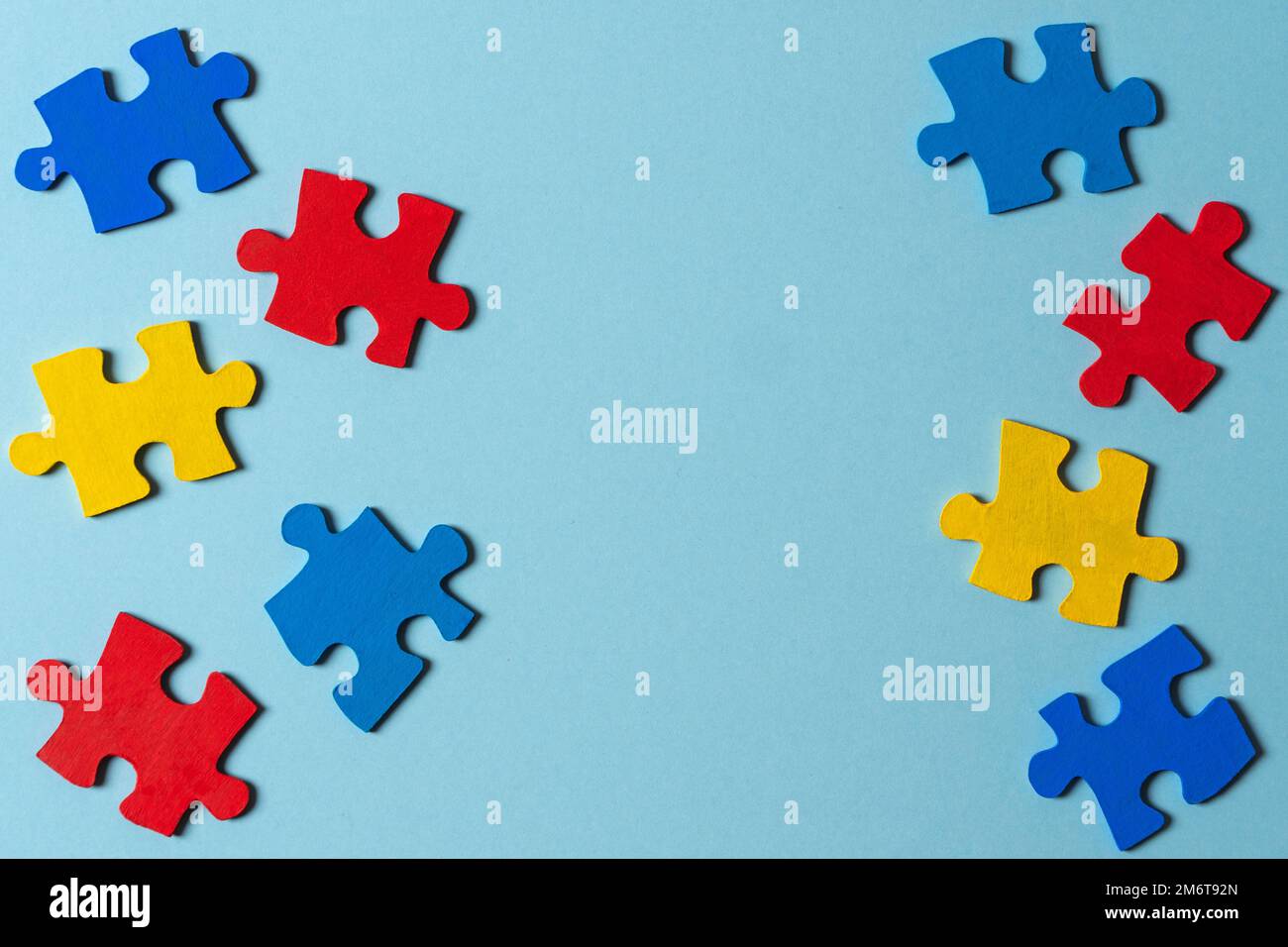 Blue, yellow, red pieces of puzzle on light blue frame background ...
