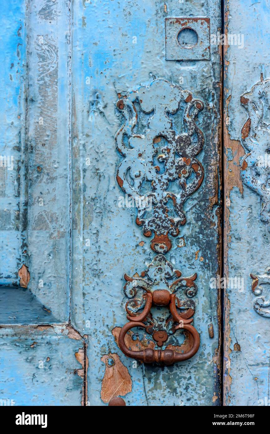 Old wooden door and lock deteriorated by time and rust in a colonial ...