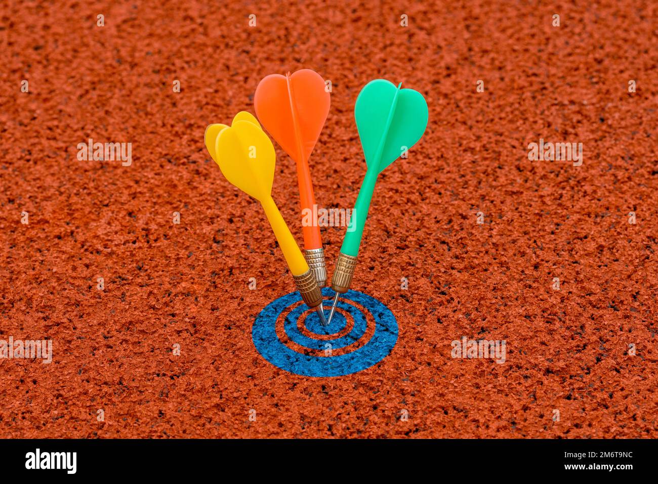 Red, green and yellow color dart arrows hits blue target Stock Photo ...
