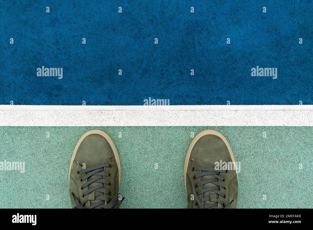 Men feet in green leather sneakers stand on the start line Stock Photo - Alamy