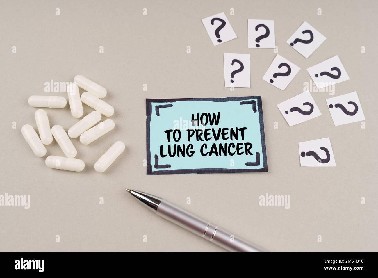 Medical concept. On a gray surface there are question marks and a blue ...