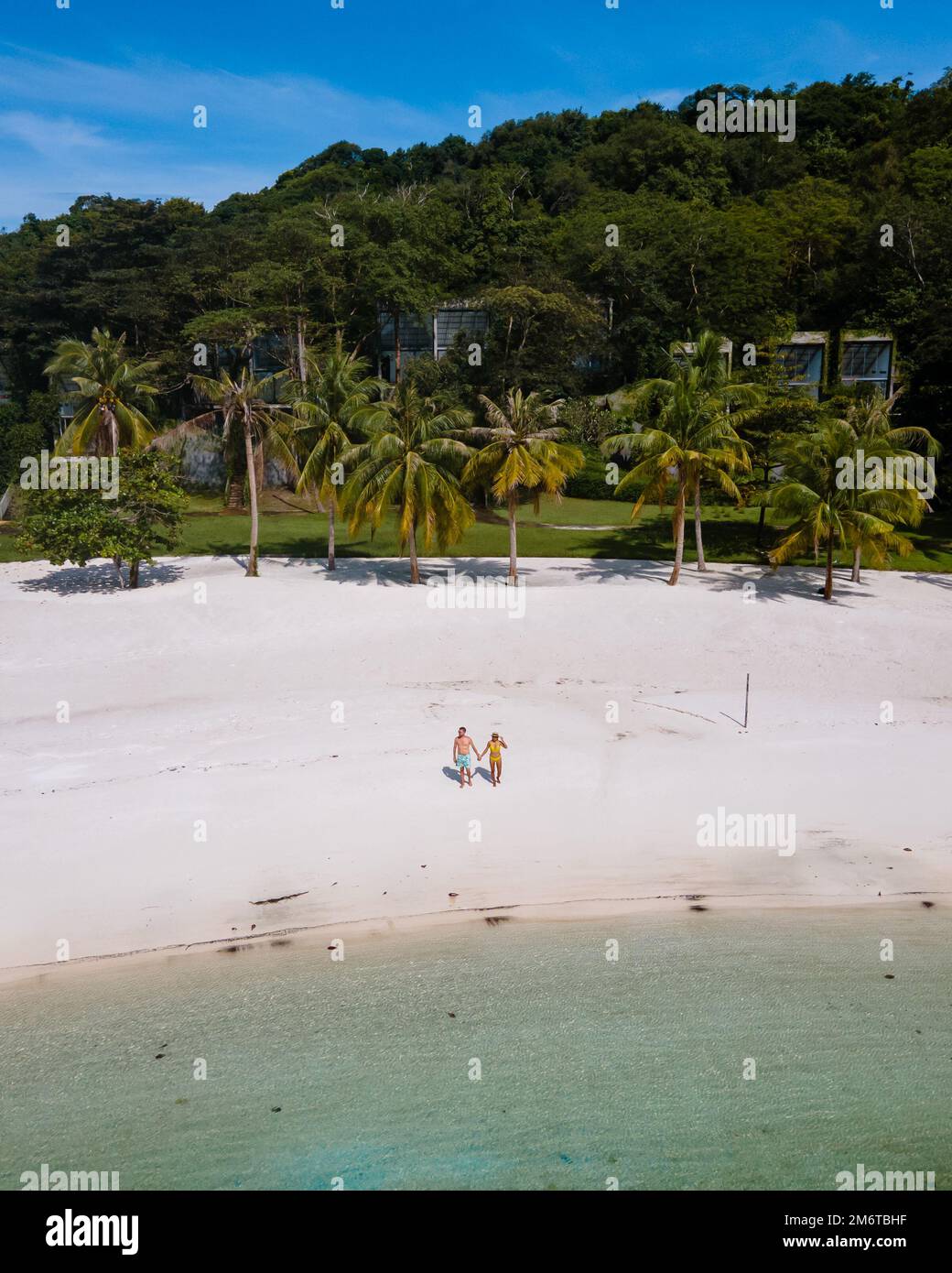 Drone aerial view couple men and women on a tropical beach in Thailand ...