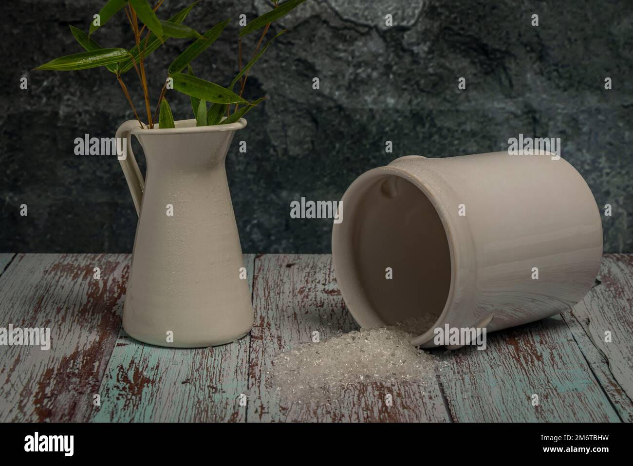 Jugs with spread ice small cubes on wooden old color table Stock Photo ...