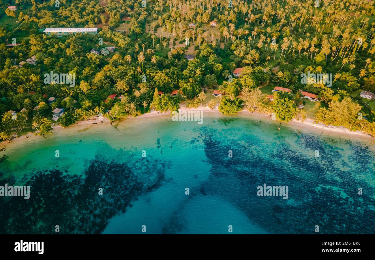 Turquoise colored ocean with palm trees from above at the Island of Koh ...