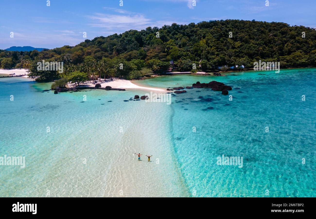 Drone aerial view couple men and women on a tropical beach in Thailand ...