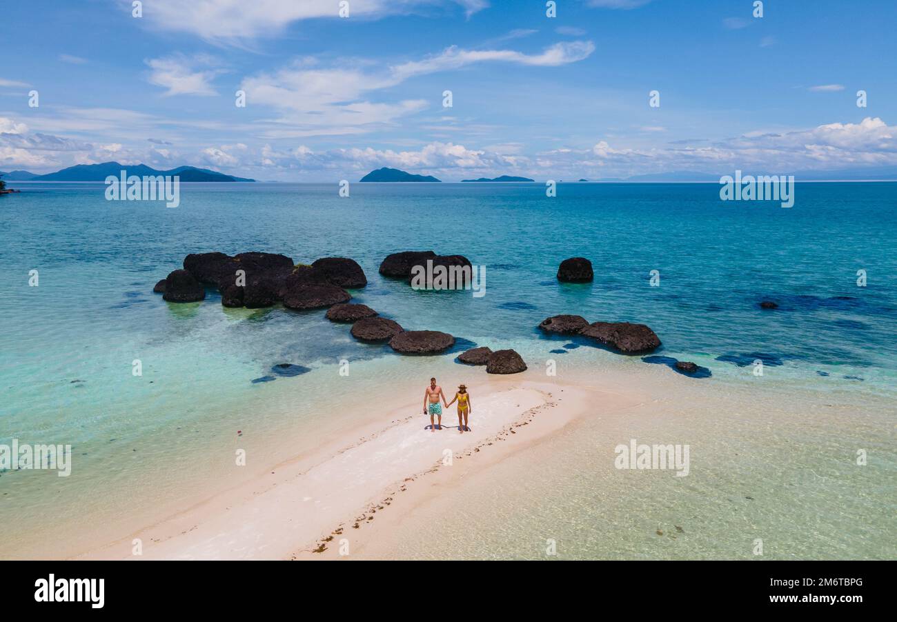 Drone aerial view couple men and women on a tropical beach in Thailand ...