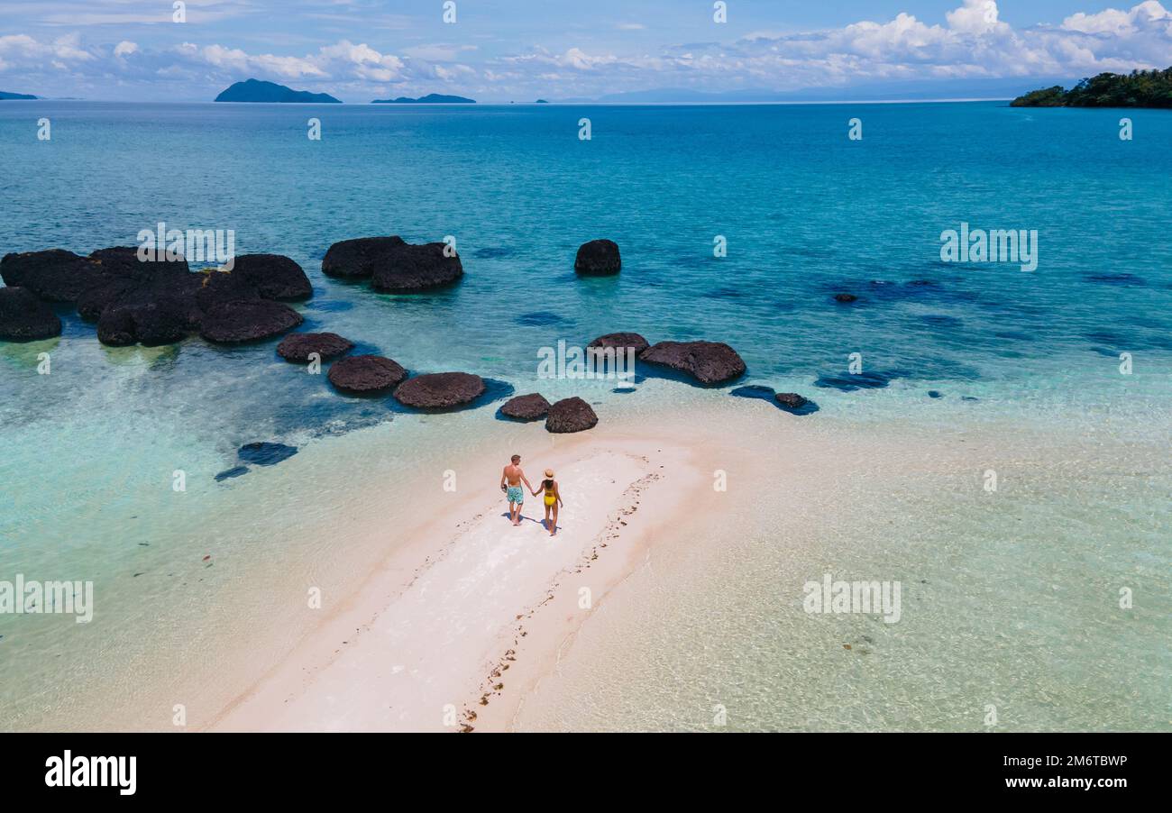 Drone aerial view couple men and women on a tropical beach in Thailand ...