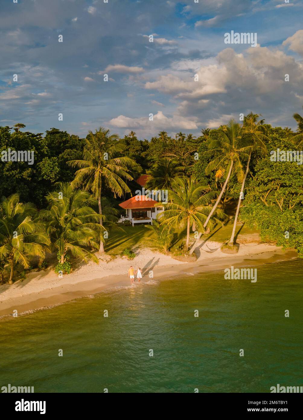 Couple men and women watching sunset on the beach of Koh Mak Trat ...