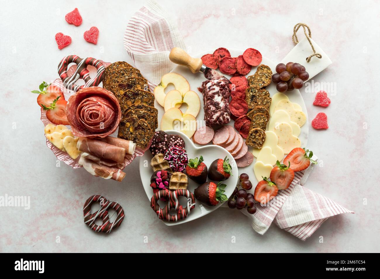 A Valentine's day charcuterie arrangement against a light background ...