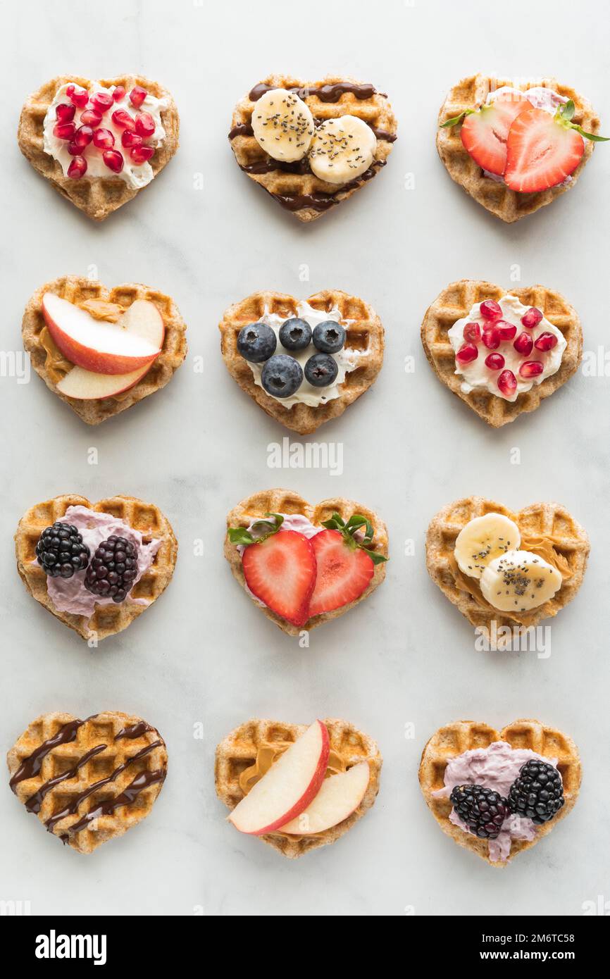 Several mini heart shaped waffles with various toppings Stock Photo - Alamy