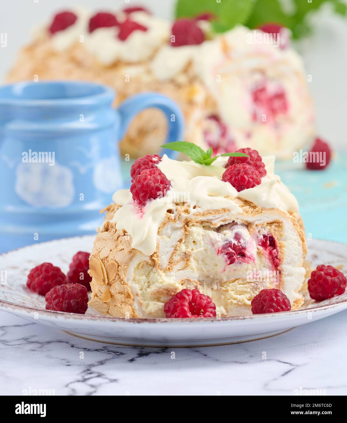 Baked meringue roll with cream and fresh red raspberry, white ...