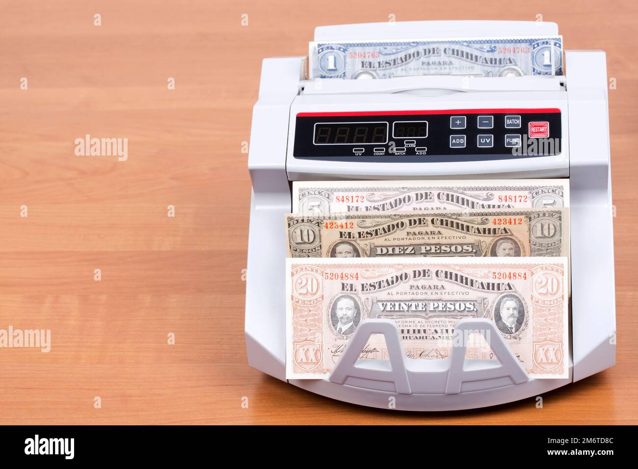 Old Mexican Pesos in the counting machine Stock Photo - Alamy