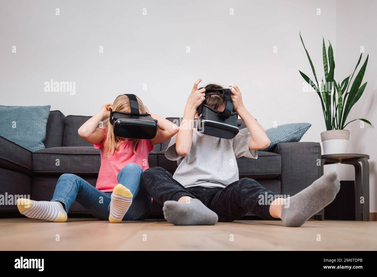 Portrait of two happy smiling children, a boy and a little girl taking ...