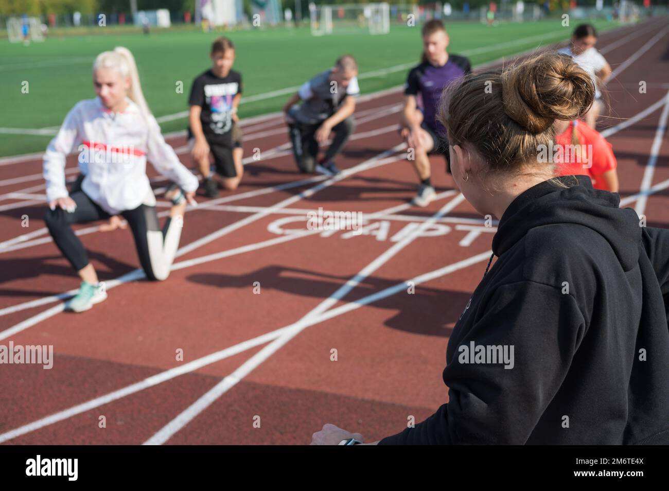 Female coach and group of children conducts a training session Stock ...