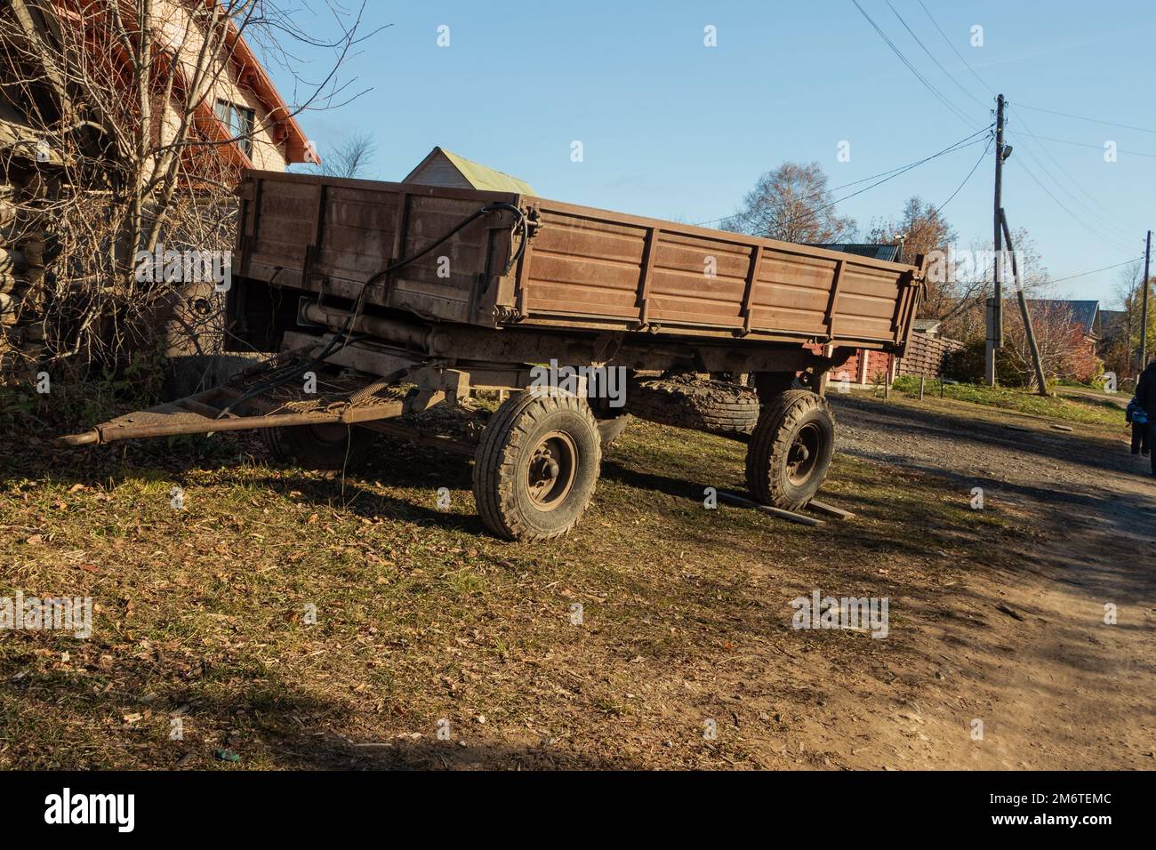 There is a tractor trailer near the road. Photo taken in the village of ...
