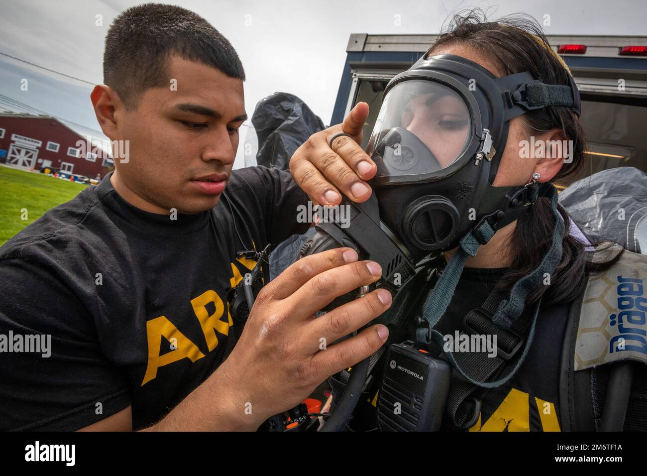 U.S. Army Sgt. Christopher Mejia, left, survey team member, assists ...