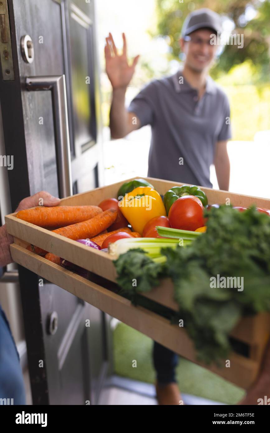 Vertical picture of happy senior caucasian men opening door and ...