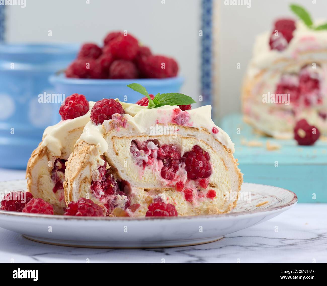 Baked meringue roll with cream and fresh red raspberry, white ...
